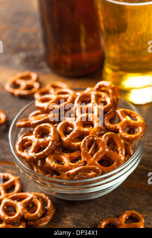 Mini pretzels. Crusty salted snack on wooden table Stock Photo - Alamy
