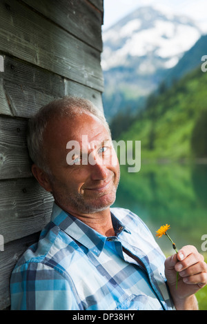 Man standing on a lake next to canoes Stock Photo - Alamy
