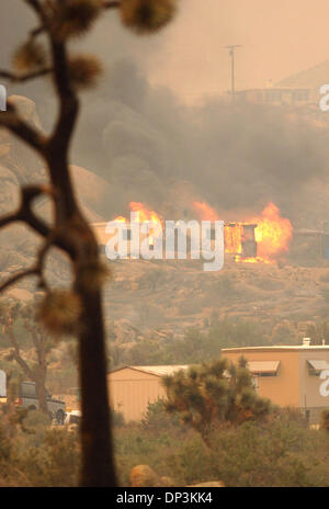 Jul 11, 2006; Yucca Valley, CA, USA; A home goes up in flames after a ...