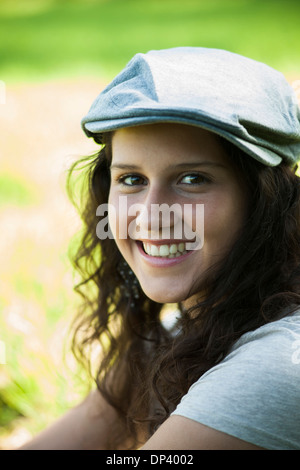 Teenage girl wearing a flat cap and giving a sideways look Stock Photo ...