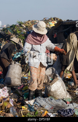 A woman scavenger is collecting recyclable material at the toxic Stung ...