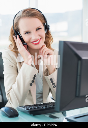 Joyful operator smiling and looking at camera Stock Photo - Alamy