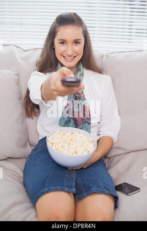 Girl Changing Channel With Remote Control In Front Of Television At ...