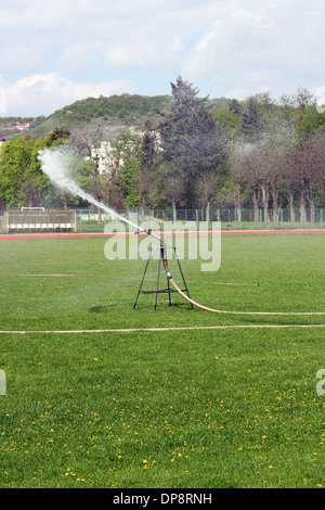 Sprinkler system in green park Stock Photo - Alamy