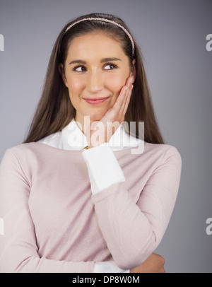 Portrait of a pretty casual girl thinking and looking away at copy ...