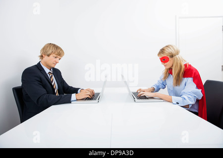 The superhero businessman working in the office Stock Photo - Alamy