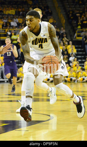 Iowa guard Roy Devyn Marble, right, passes around Michigan guard Darius ...