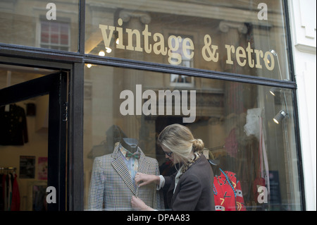 Woman putting jacket on shop dummy Stock Photo - Alamy
