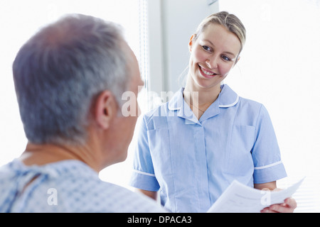 Nurse having conversation with patient Stock Photo - Alamy