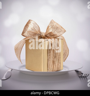 Luxurious gift on plate. Feast concept Stock Photo - Alamy