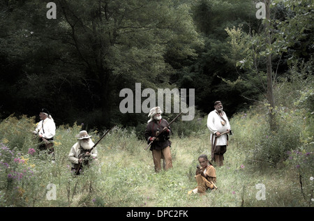 Mountainmen trappers and a Native American Indian boy go hunting Stock ...