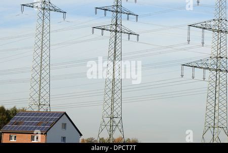 Solar panels with high voltage pylons on blue sky, electricity ...