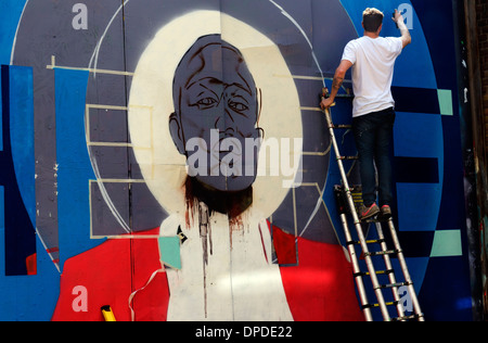 Man on a ladder spray painting Approved Wall Art Graffiti in Brick Lane ...