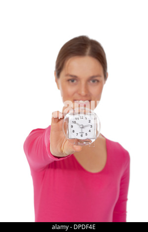 Happy young woman with alarm clock sitting in bedroom Stock Photo - Alamy