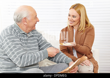 Senior woman and man having breakfast sitting in their garden Stock ...