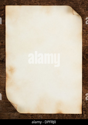 Sheet of old paper with curled edges on the wooden background Stock ...