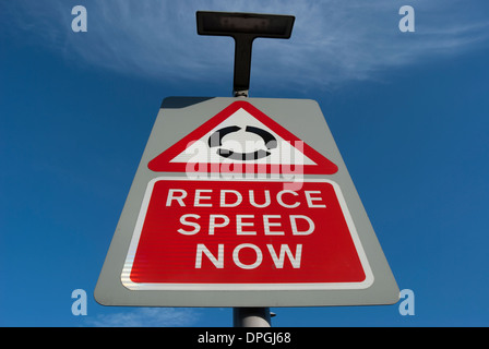 Reduce speed now roundabout ahead road sign Stock Photo - Alamy