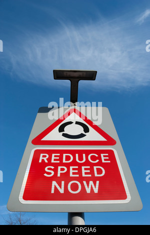 Reduce speed now roundabout ahead road sign Stock Photo - Alamy