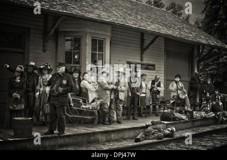 Group of old fashioned towns people waiting for the train at the train ...