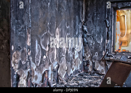 Fire damaged room. Black burnt out wood. Pstel pinted walls. Dramatic ...