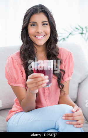Cheerful woman sitting on glass balcony enjoying beautiful green ...