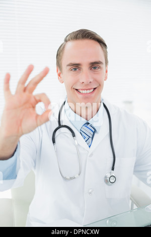 Doctor gesturing okay hand sign, symbol and emoji to express success ...