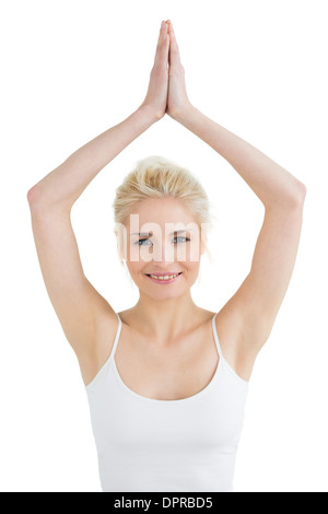 Woman with joined hands over head at fitness studio Stock Photo - Alamy