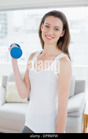 a woman raising a dumbbell Stock Photo - Alamy