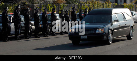 Members of the Tracy Police salute as a hearse carrying the body of ...