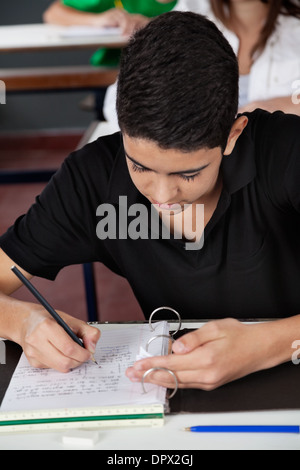 Male high school student copying classmate's work Stock Photo - Alamy