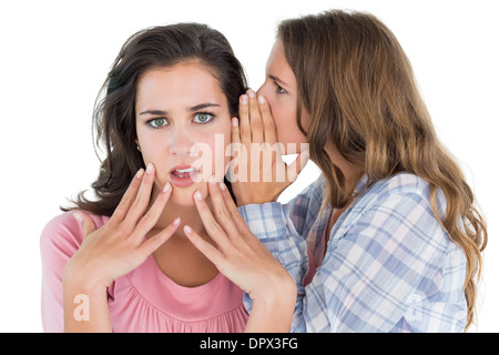 Two young female friends gossiping Stock Photo - Alamy