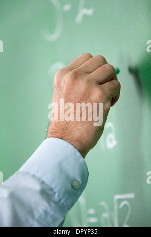 Male Professor Writing On Greenboard Stock Photo - Alamy