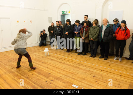 Performance Art - people watching a woman artist performing live art in ...