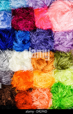 Different color "grass" threads on rows in the store Stock Photo - Alamy