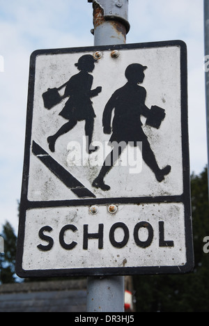 An old fashioned warning sign for a school in the famous pretty village ...