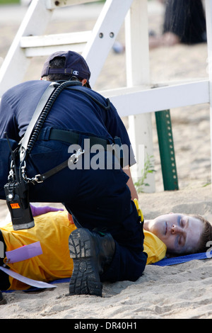 An EMT at a scene of a mass casulty incident is checking on one of the ...