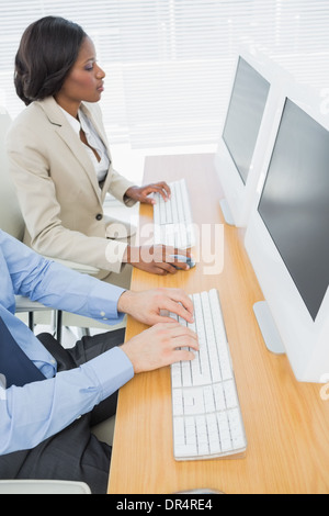 Business colleagues using computers at desk Stock Photo - Alamy