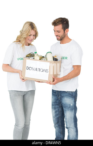 Young hispanic woman holding cardboard box at moving smiling happy ...