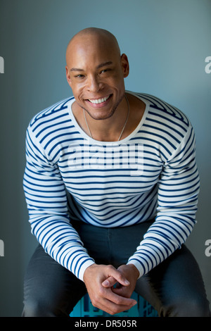 Adult man in striped t-shirt screaming and rubbing temples because of ...