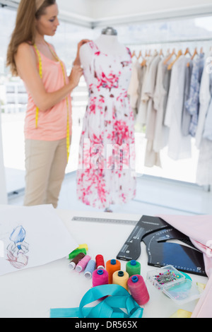 Female dress designer working in a boutique Stock Photo - Alamy