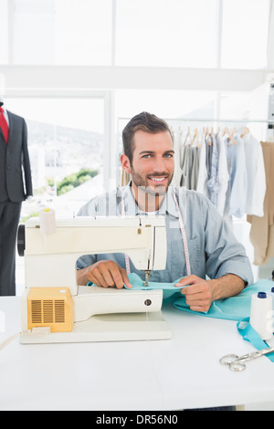 Male tailor sitting at sewing machine and sewing Stock Photo - Alamy