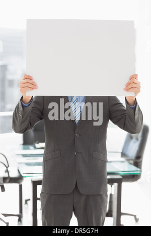 Businessman covering his face with placard Stock Photo - Alamy