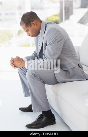 worried man sitting on the couch Stock Photo - Alamy