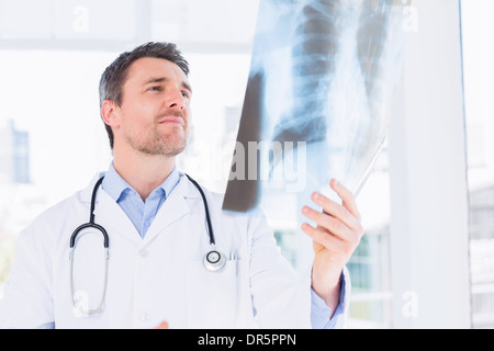 Serious male doctor examining x-ray Stock Photo - Alamy