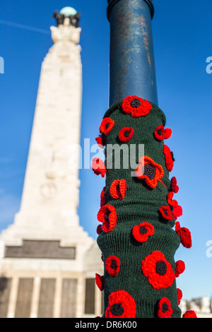 Hand crochetted and knitted red poppies on lamp post in front of the ...