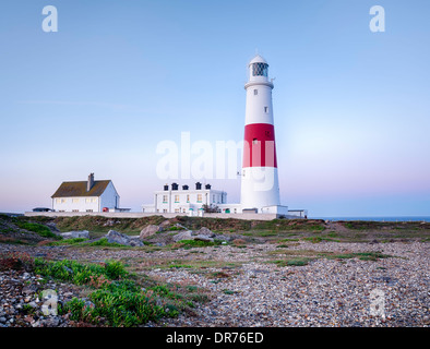 Sun setting at Portland Bill lighthouse with the coastal jurassic rocks ...