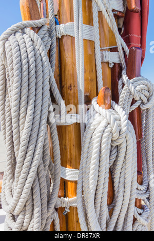 Details of the sailing yacht with ropes, knots and wood plank on deck ...