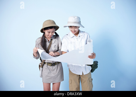 kids dressed as explorers while looking at a map Stock Photo - Alamy