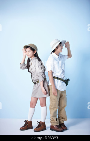 Side view of cute Asian schoolboy studying at desk in classroom at ...