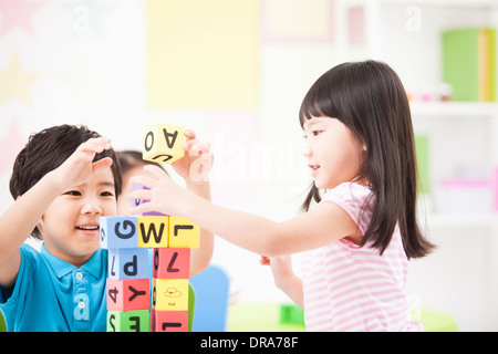 boy and girl of playing with cubes Stock Photo - Alamy